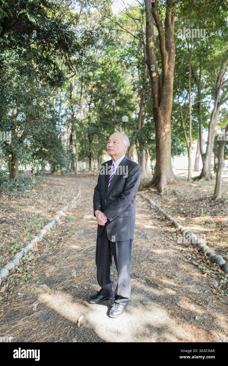 A park on a pleasant spring daytime with plenty of greenery in Japan. A ...