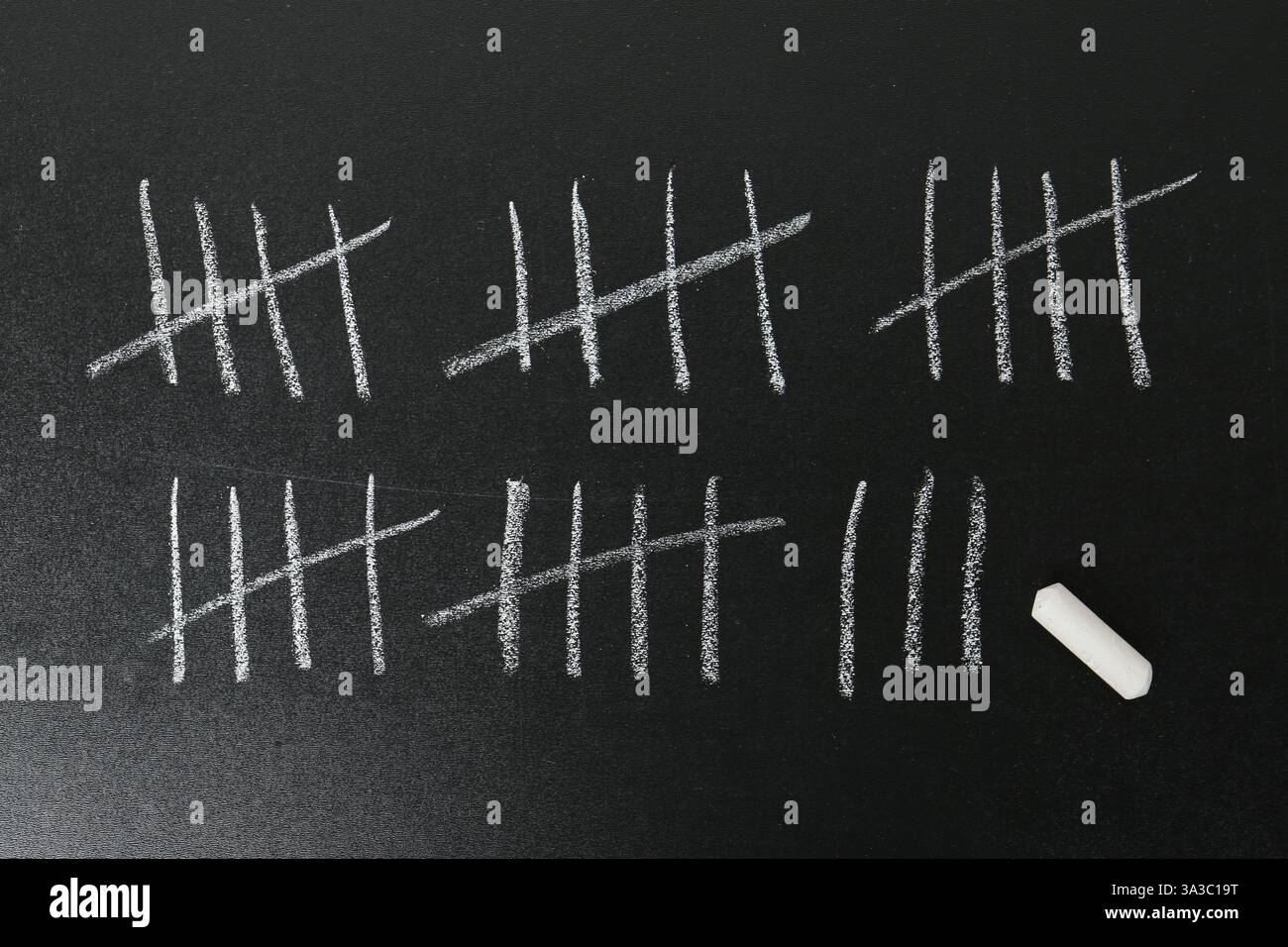 Counting days by drawing sticks with chalk on blackboard, closeup Stock ...