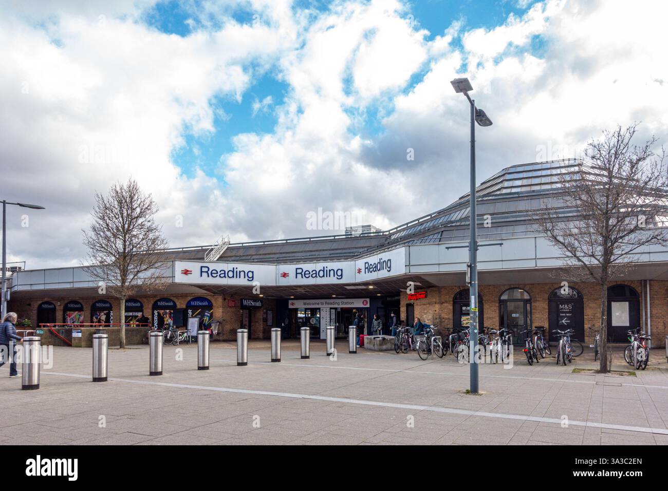 A view of the front of Reading railway station with a line of bollards ...