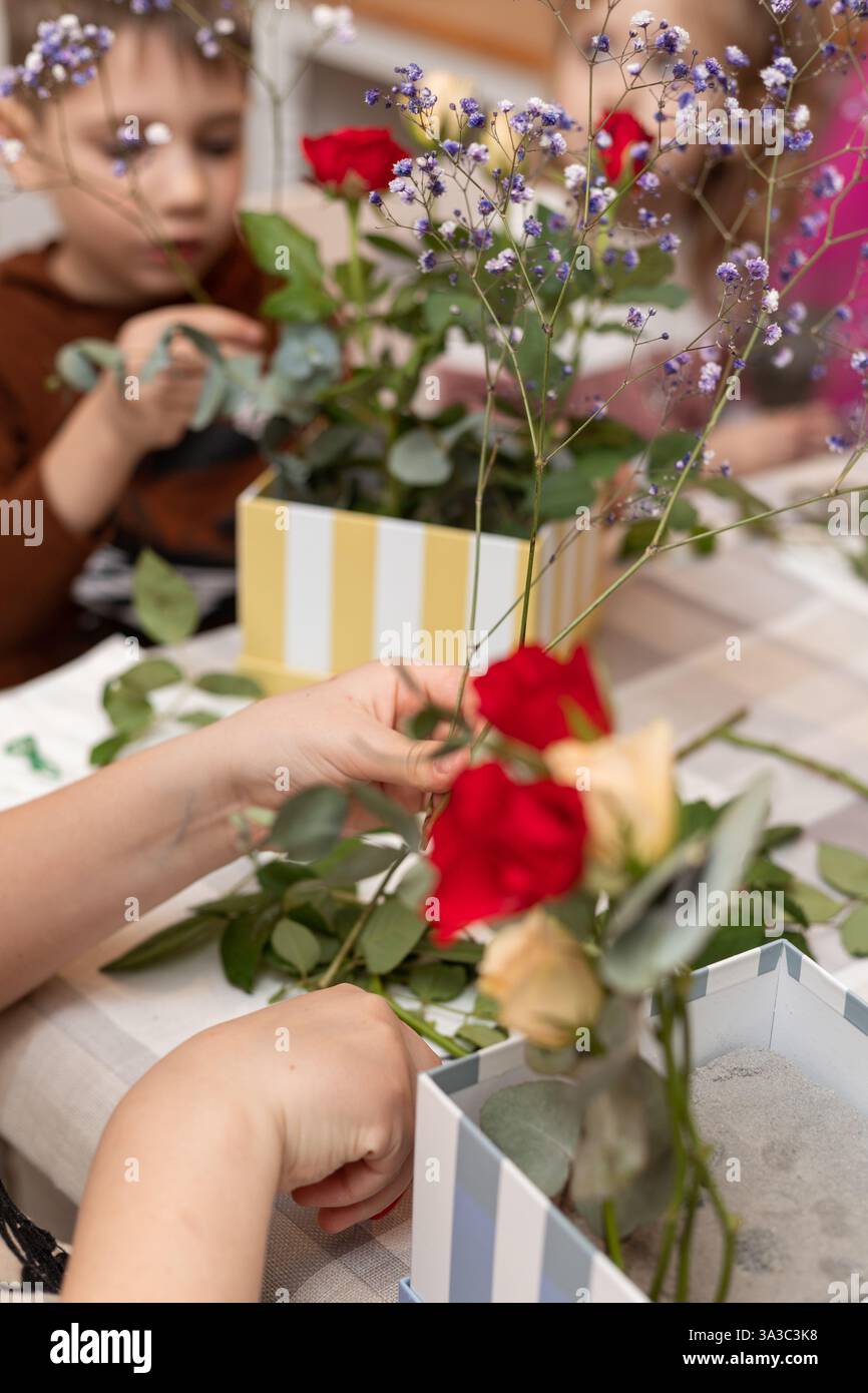 A child makes a handicraft with his own hands for Mother's Day. Boy ...