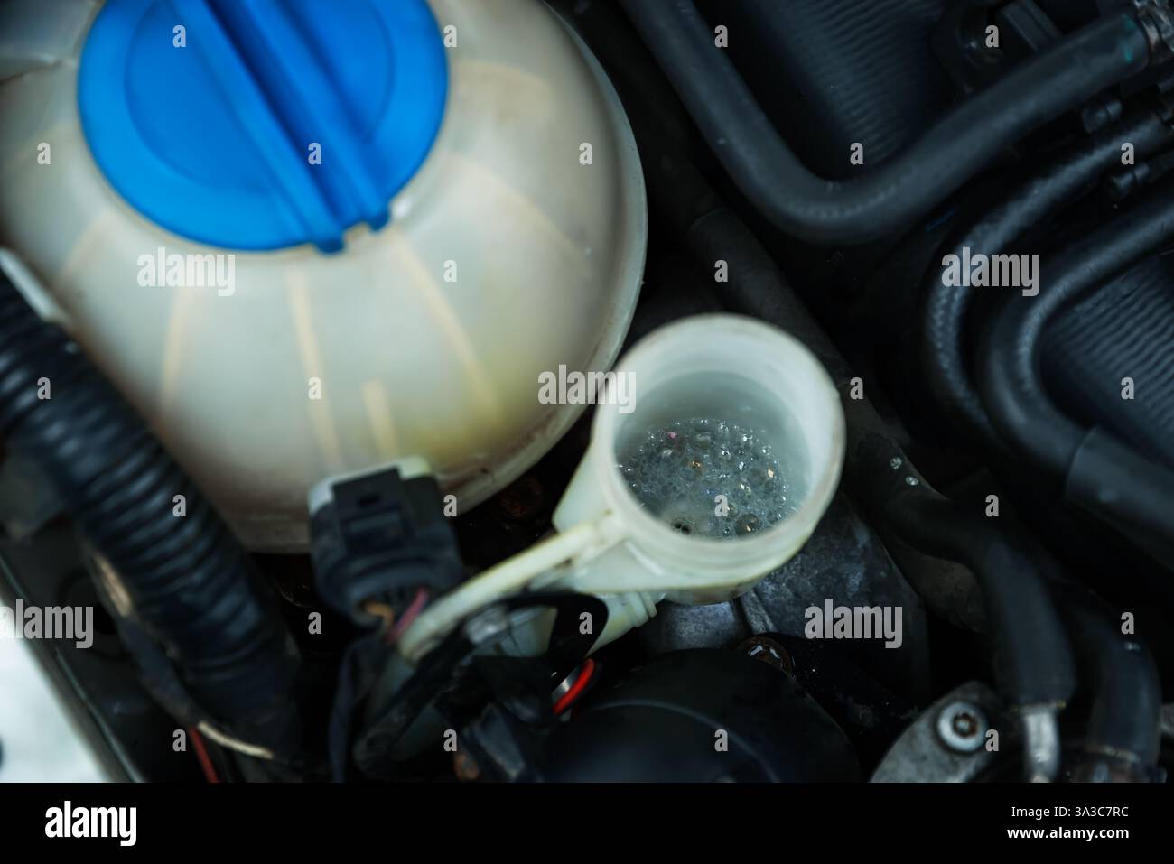 Windshield washer reservoir with fluid, closeup view Stock Photo - Alamy