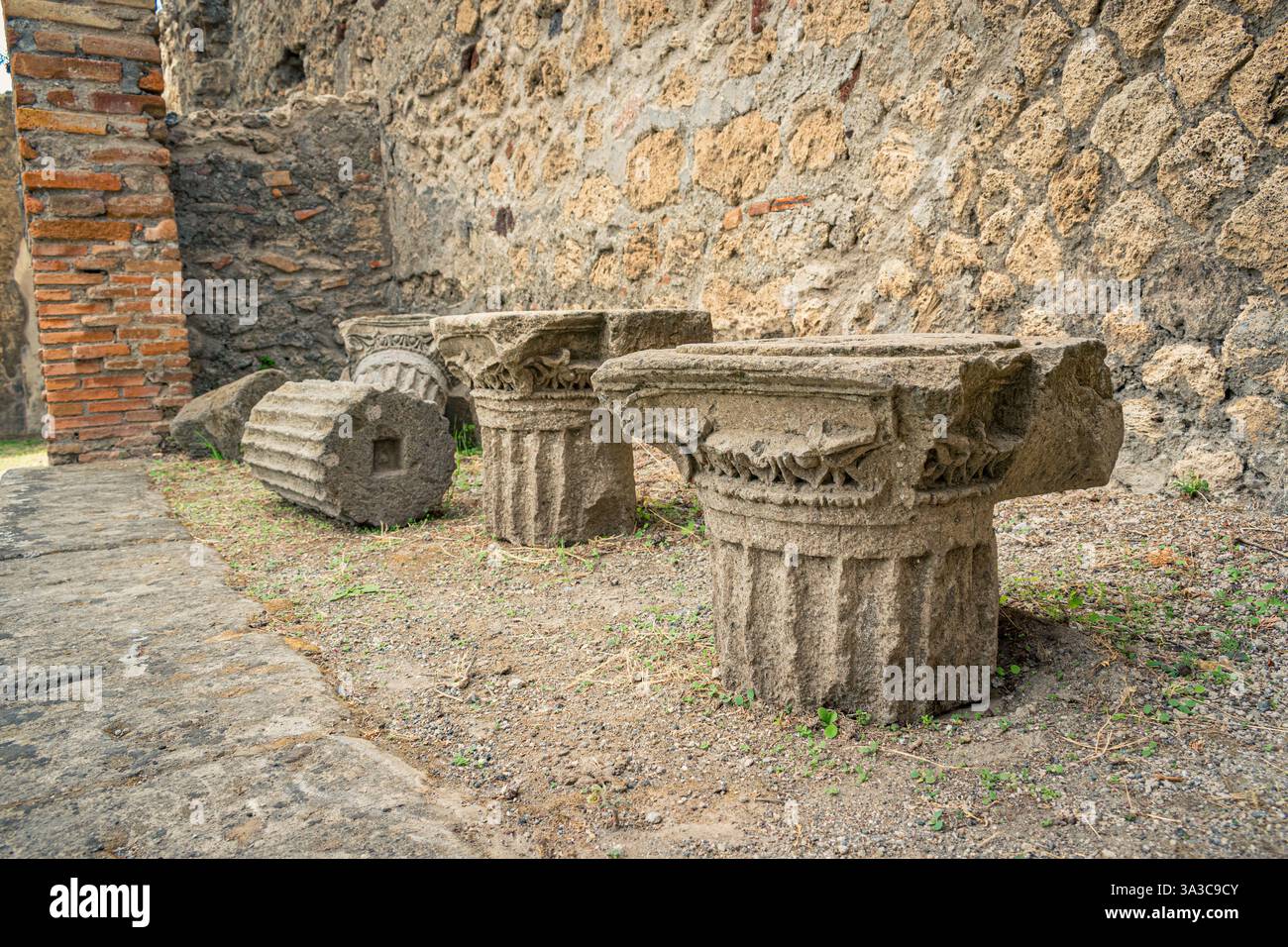 Explore intricate details of ancient carved columns amidst the historic ruins of Pompeii, Italy ...