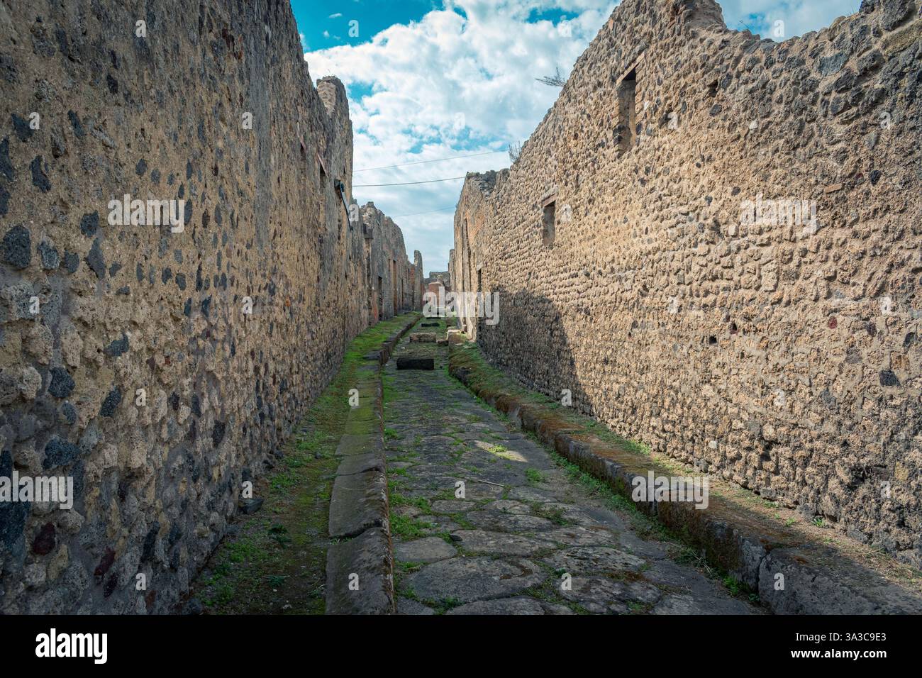 Ancient stone pathway flanked by weathered stone walls and remnants of ...