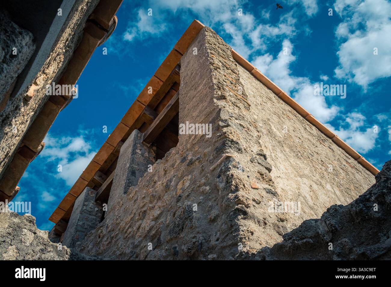 View of a rustic stone structure with a tiled roof, featuring clear ...