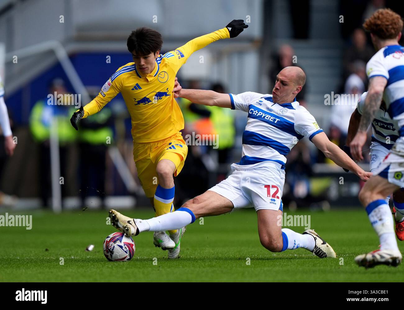 Leeds United's Ao Tanaka (left) and Queens Park Rangers' Michael Frey ...