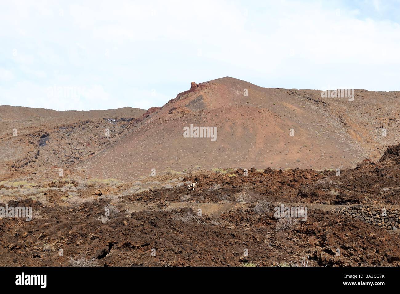 stunning volcanic landscape, rugged lava rock and patches of green ...