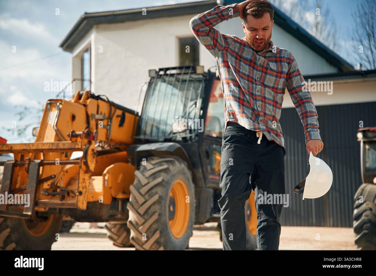 Mad, angry emotion. Man is with tractor. Agricultural worker Stock ...