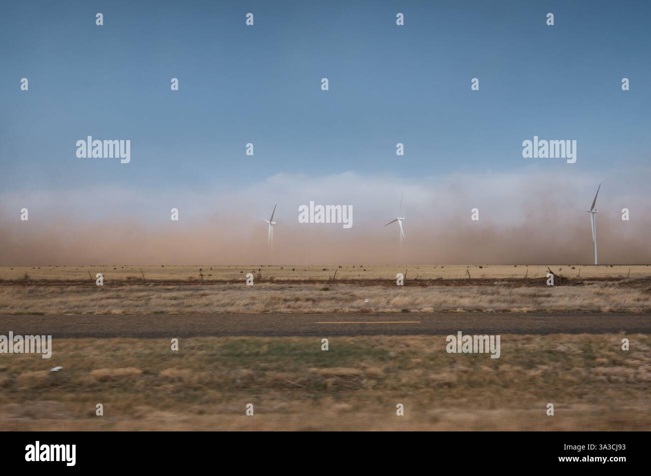 Wind turbines along the highway during a dangerous spring dust storm ...