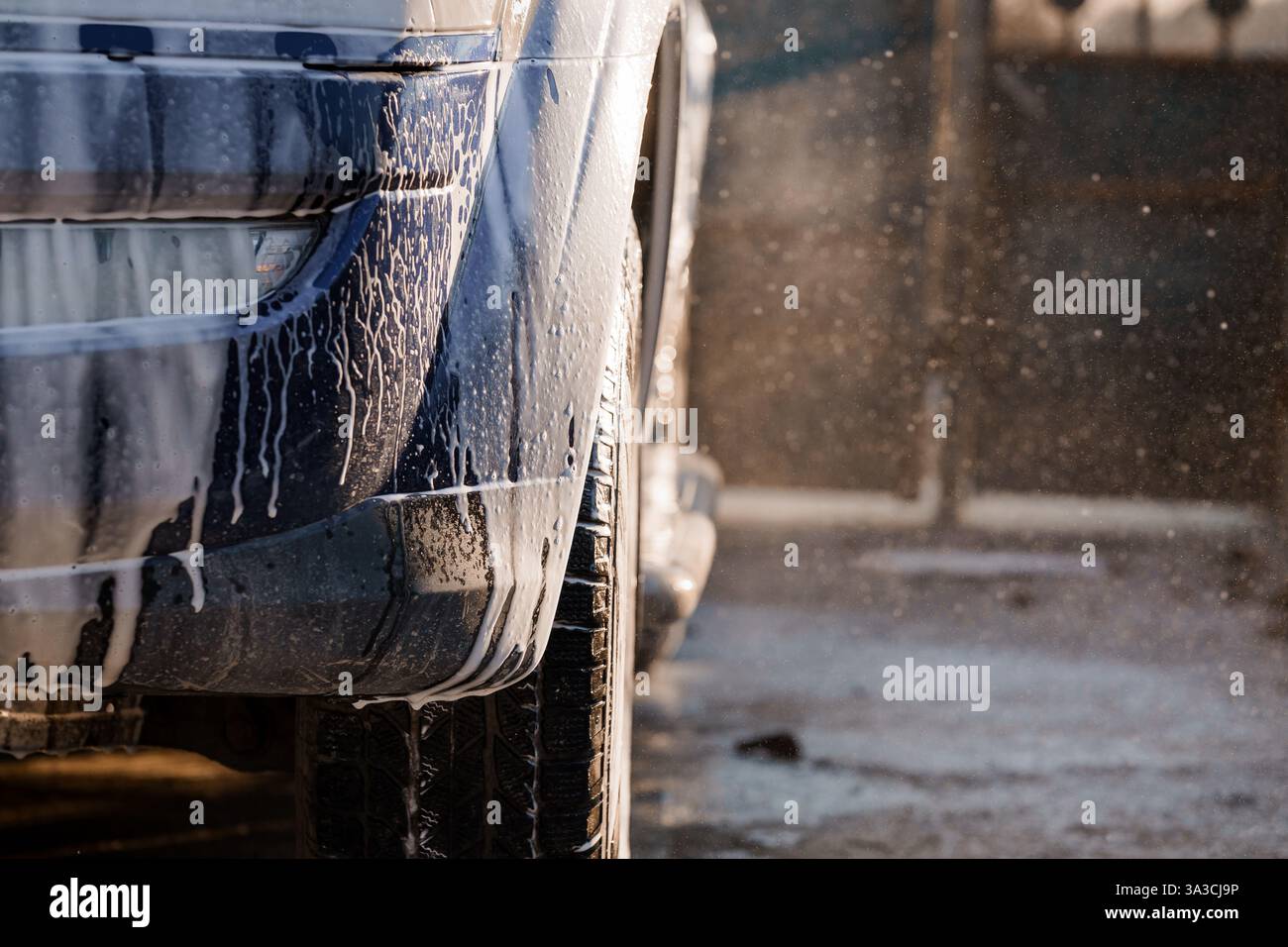 Close-Up View of Car Featuring Foam Soap, Water Droplets, and Tires ...