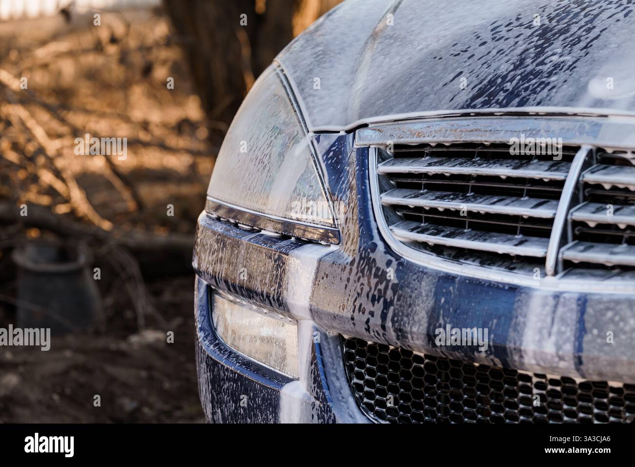 Close-Up Front View of Car Covered in Soapy Foam During Car Wash ...