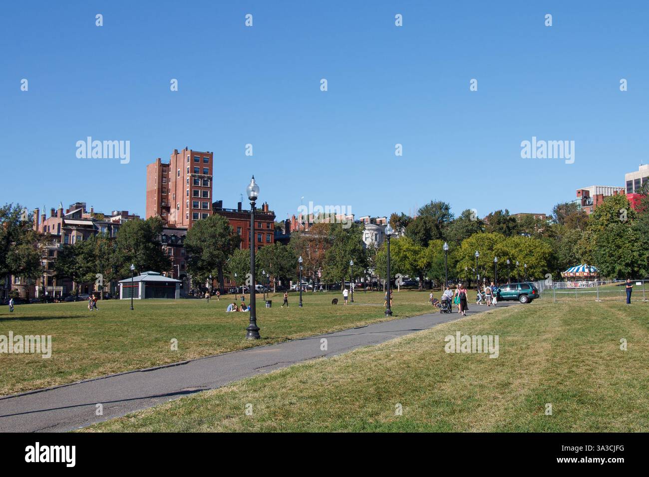 People walking on Boston Common and the skyline of the city historic ...