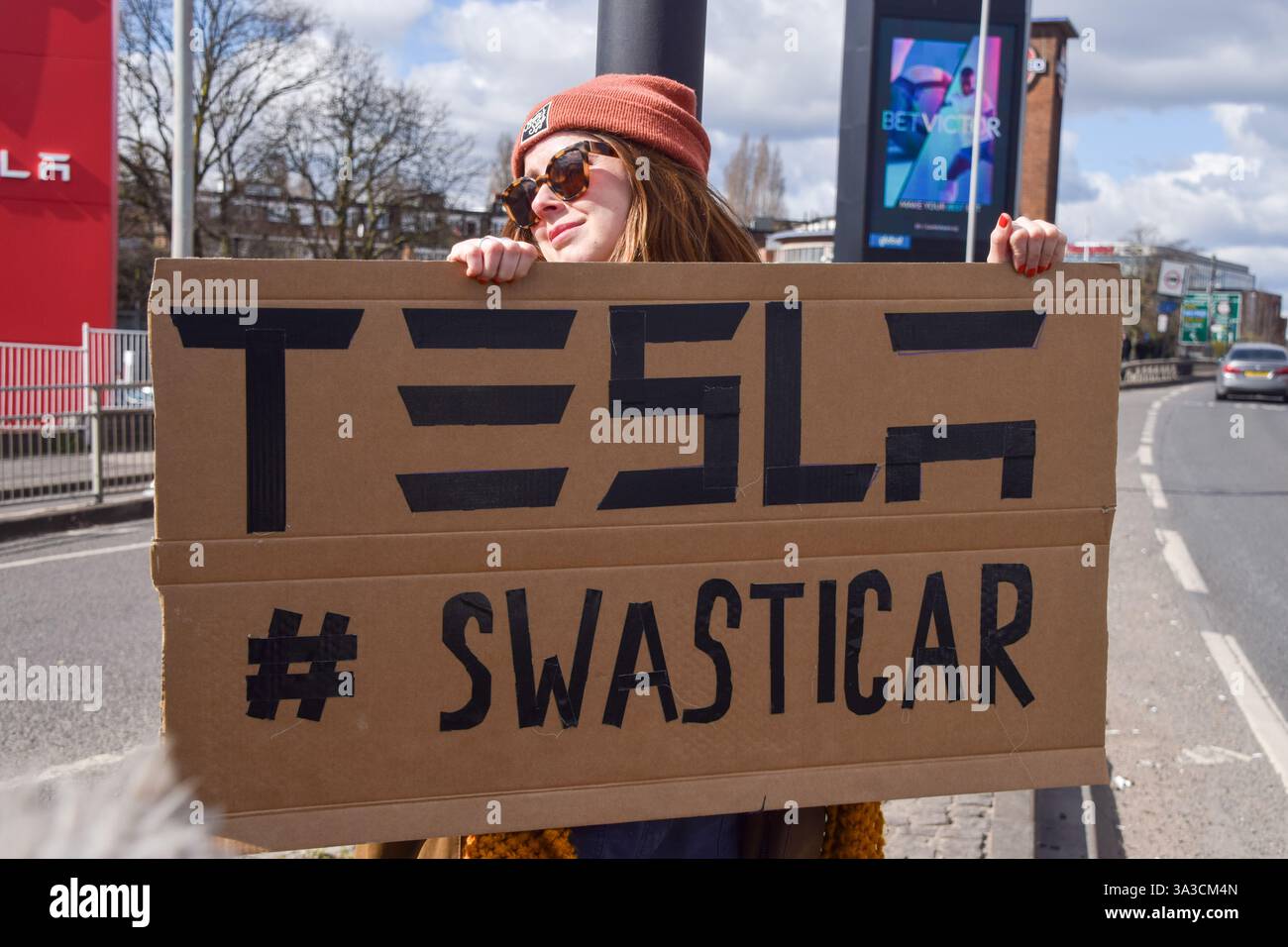 March 15, 2025, London, England, UK: A protester holds a 'Tesla ...