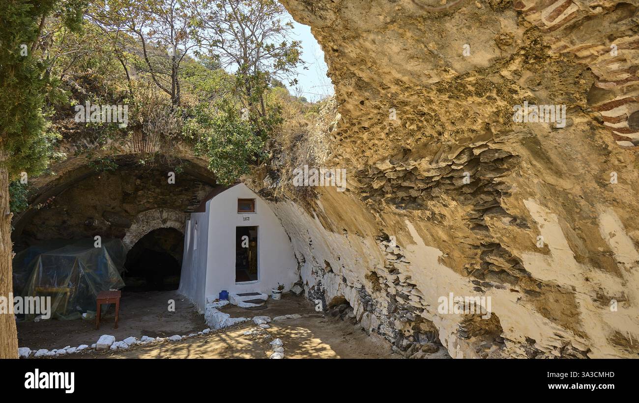 Rustic white structure in a natural cave by daylight, Panagia Thermiani ...