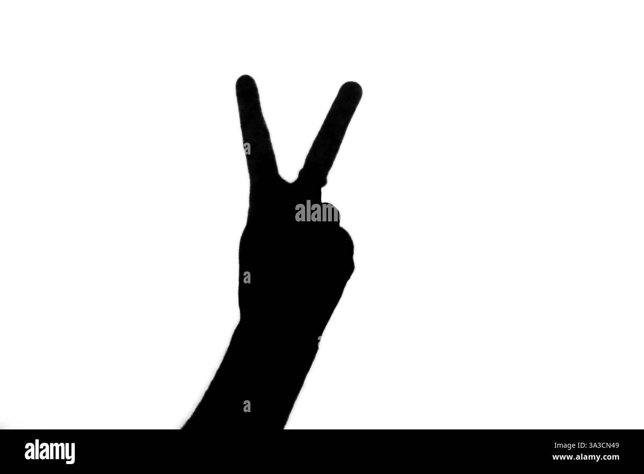 Shadow image, black and white silhouette of a hand with two spread ...