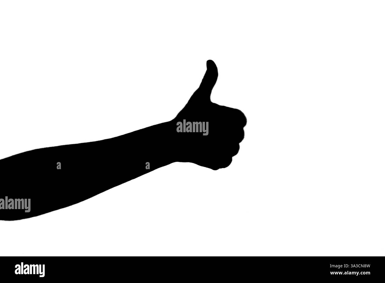 Shadow image, black and white silhouette of a hand with thumbs up as a ...