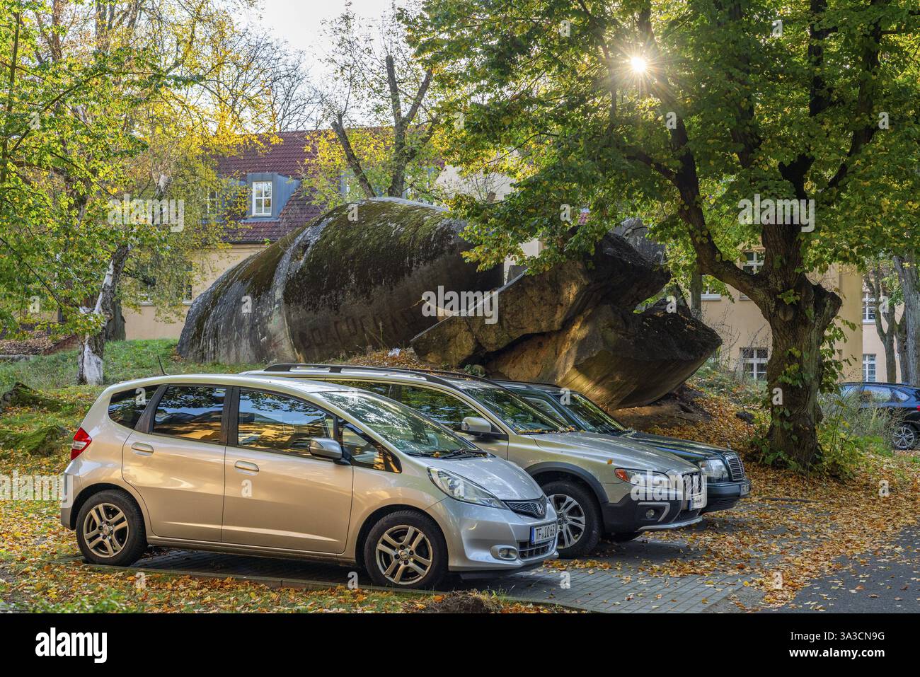 Cars on a car park in front of the broken remains of a historic pointed ...