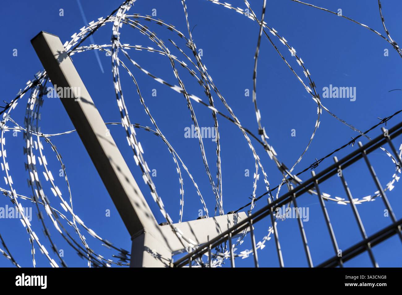 Symbolic image security, S-wire rolls, NATO wire, on a fence top ...