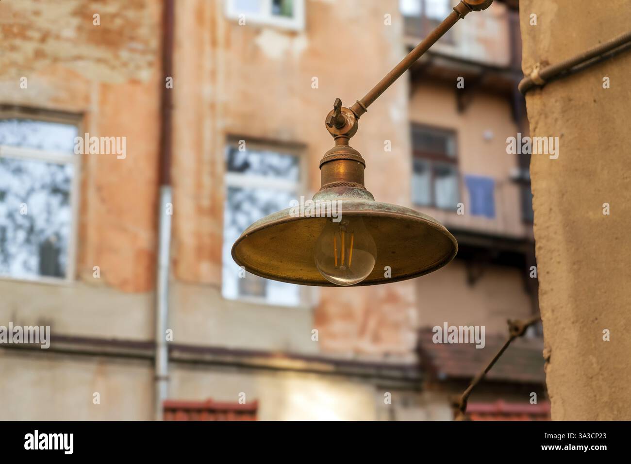 Vintage brass lamp on historic building wall. Old-Fashioned lantern on ...