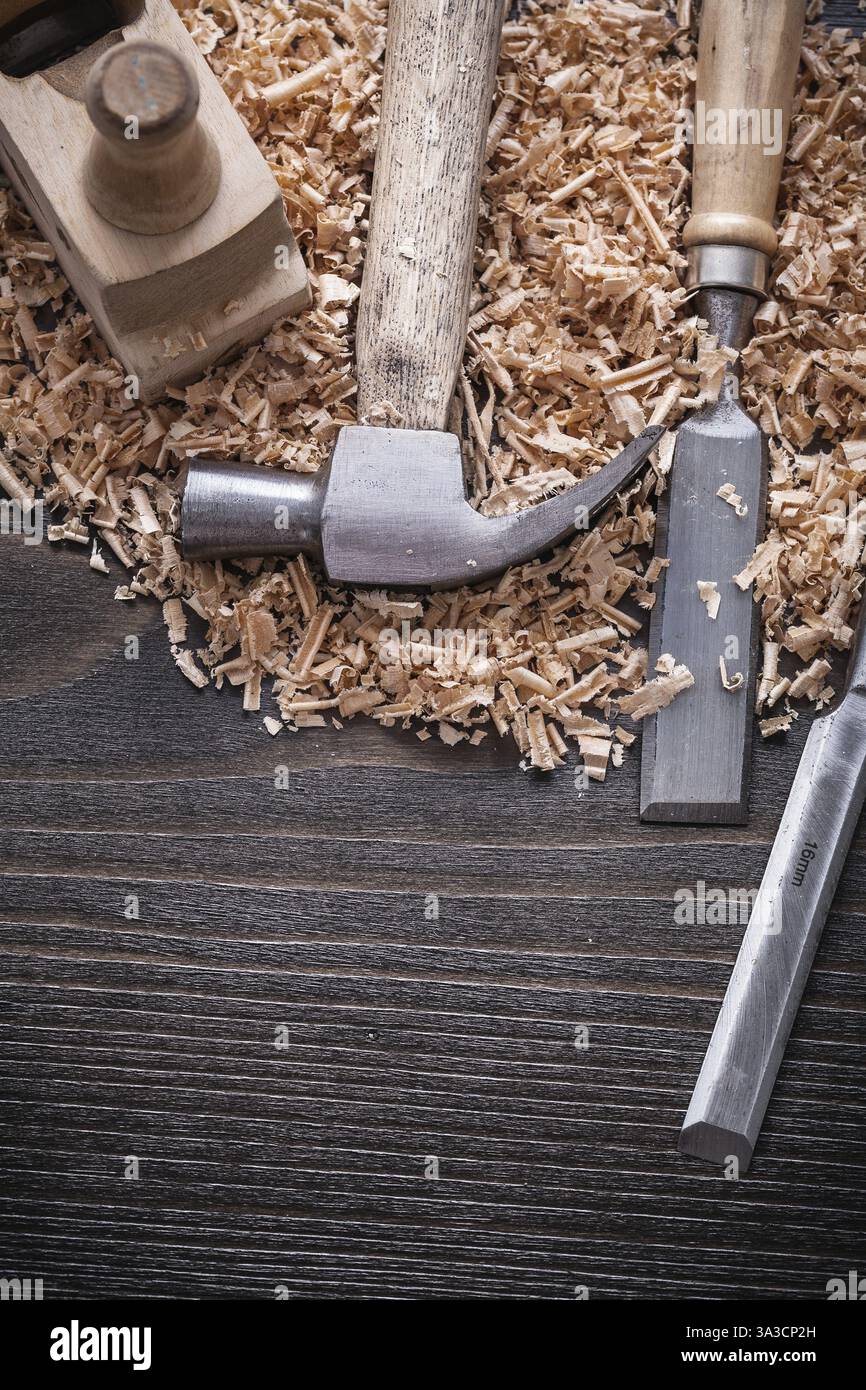 Vertical view of claw hammer chisels wooden shaving plane and planning ...