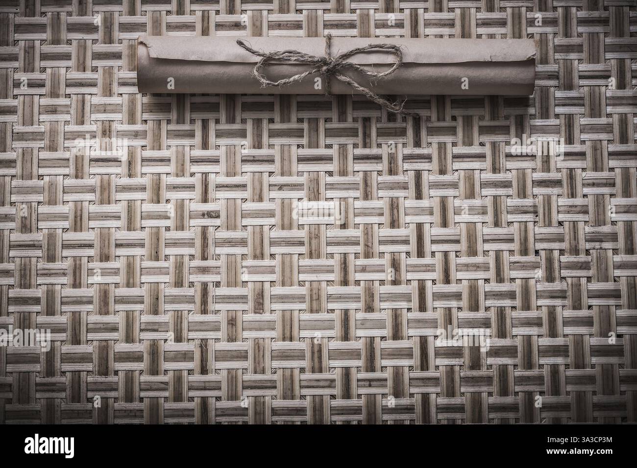 Vintage rolled document on wicker wooden mat Stock Photo - Alamy