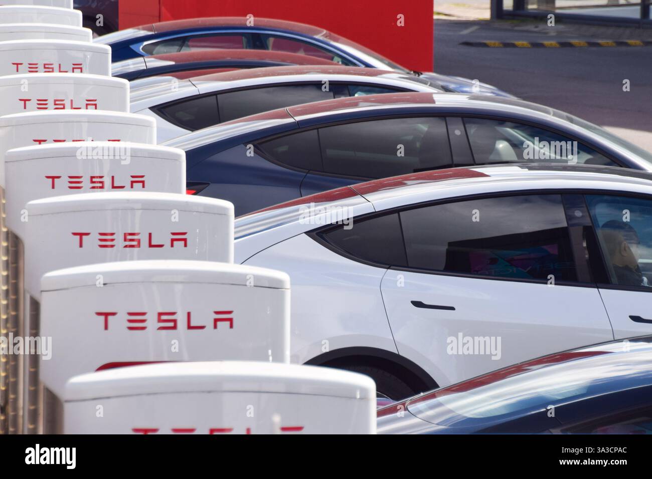 March 15, 2025, London, England, UK: Cars charging at the Tesla Centre ...