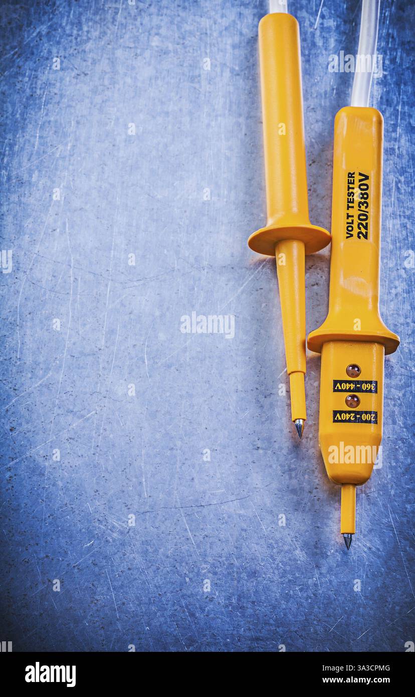 Yellow electrical tester on scratched metallic background Stock Photo ...