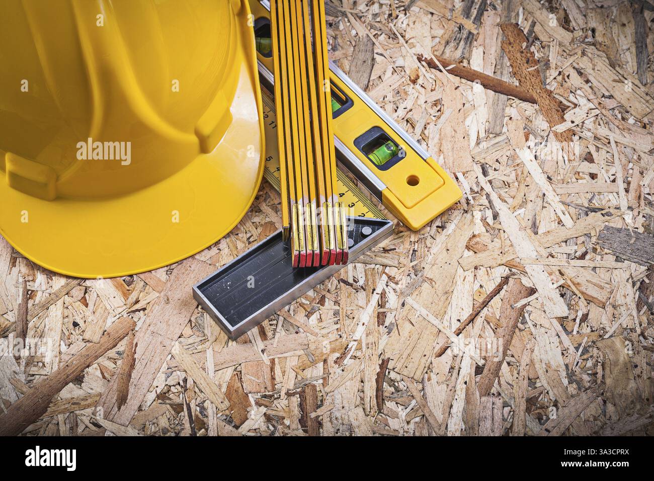 Square ruler construction level wooden meter hard hat on chipboard ...