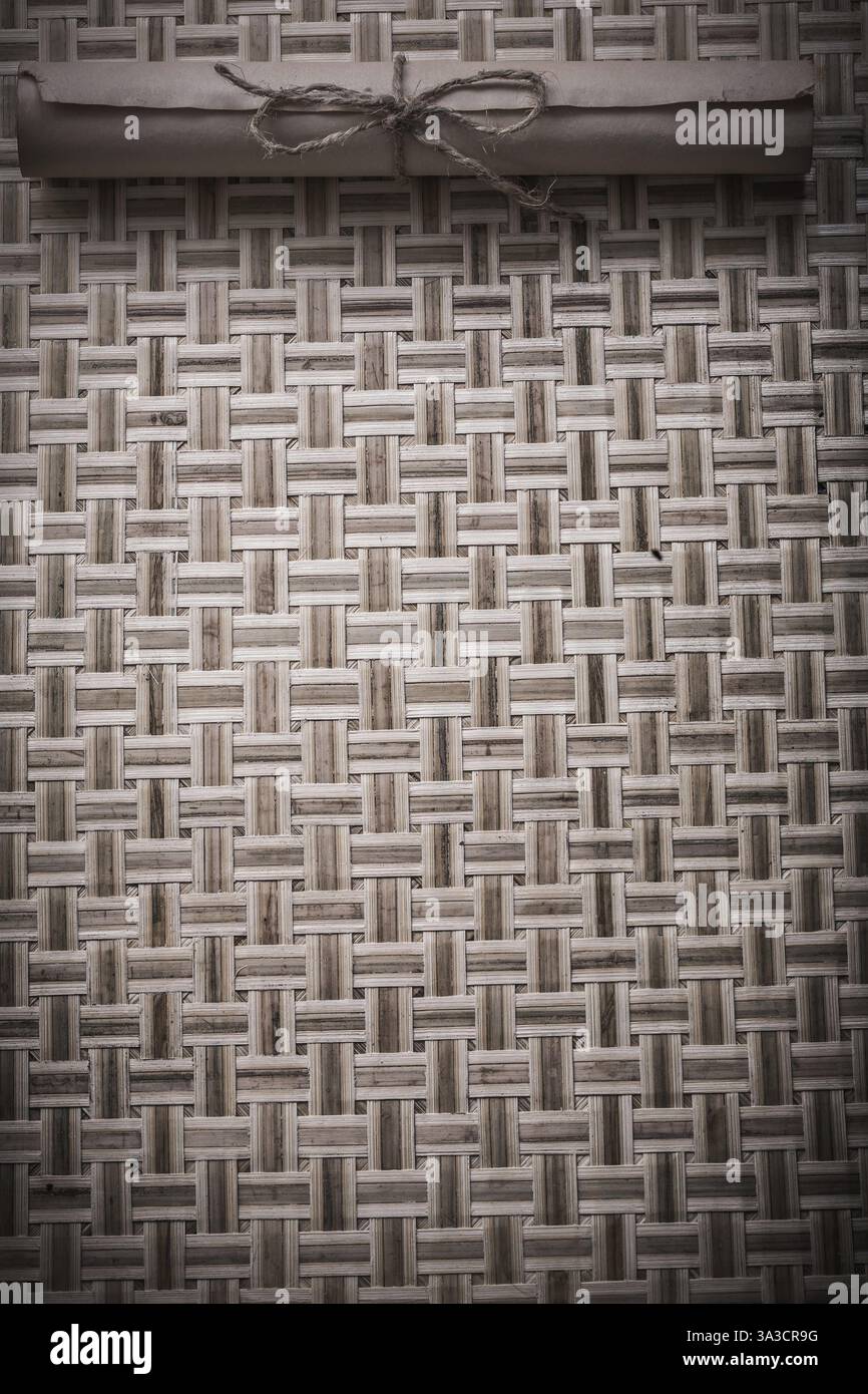 Vintage rolled document on wicker wooden mat copy space Stock Photo - Alamy