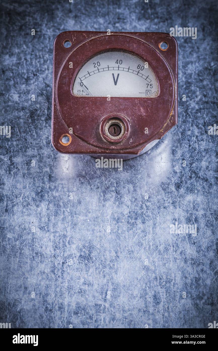 Voltmeter on scratched metallic background vertical view vintage ...