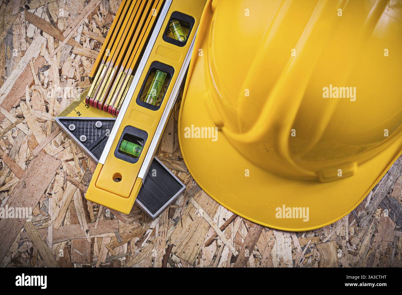 Square ruler construction level hard hat wooden meter on OSB Stock ...