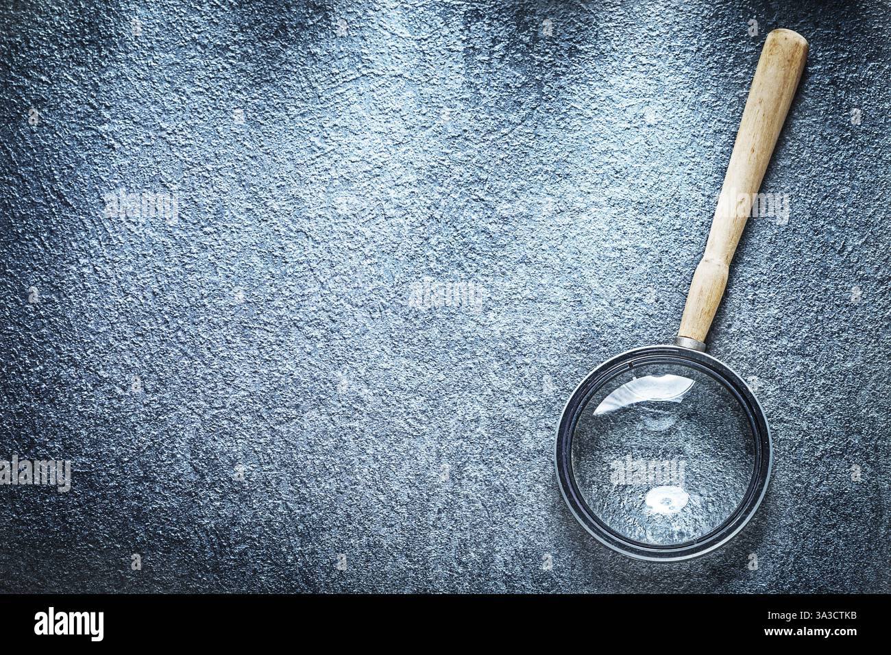 Vintage magnifier with wooden handle on black surface Stock Photo - Alamy