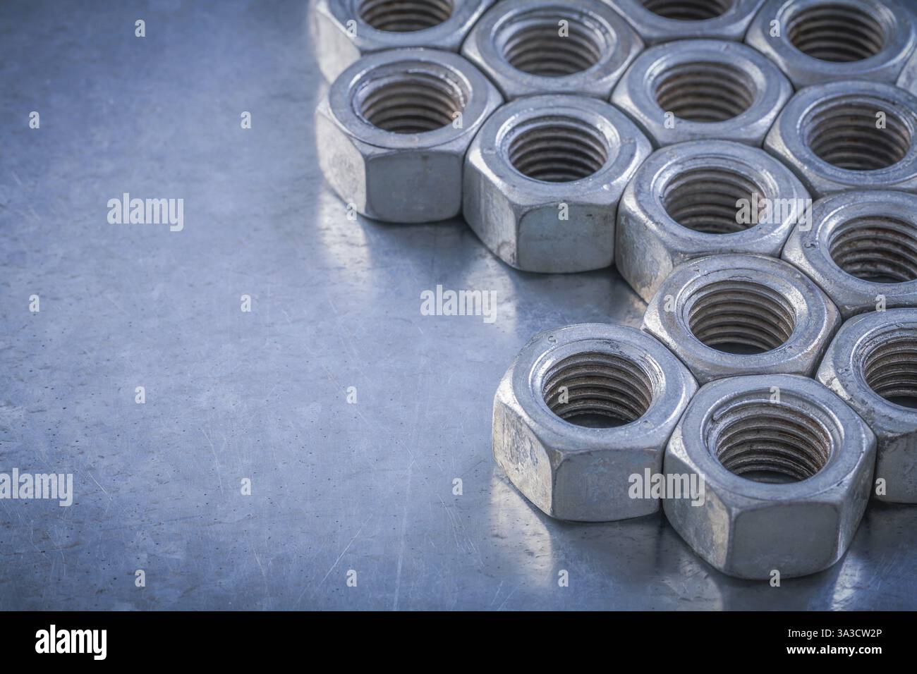 Stack of screw-nuts on metallic background maintenance concept Stock ...