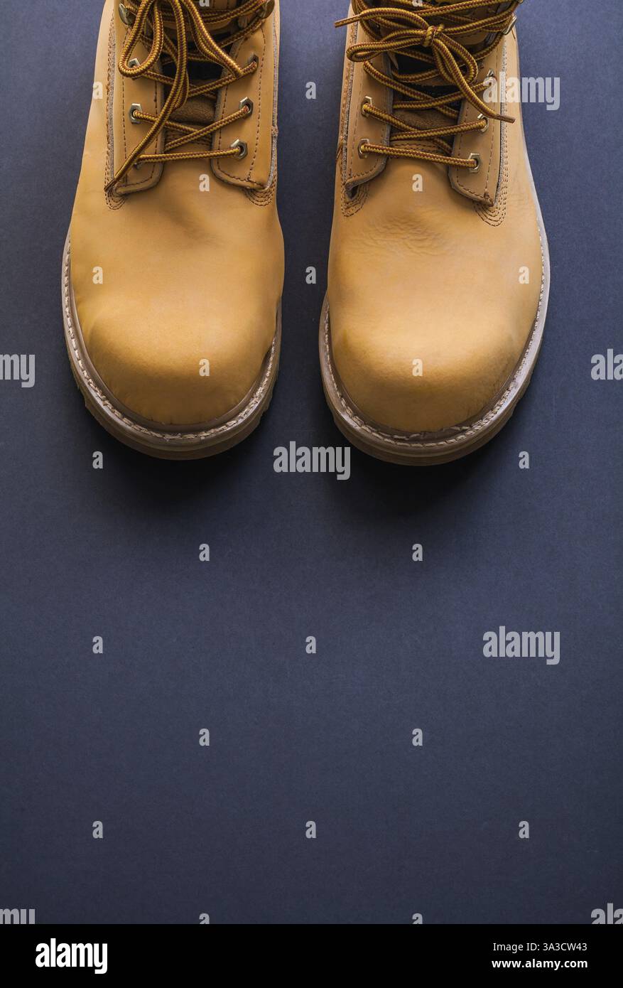 Very close up view working boots on black background Stock Photo - Alamy