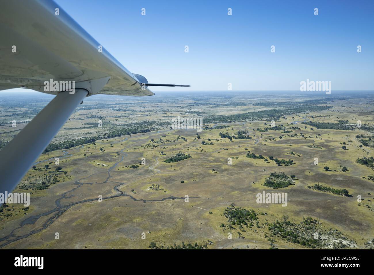 Okavango Delta aerial view with aeroplane wing, Moremi Game Reserve ...