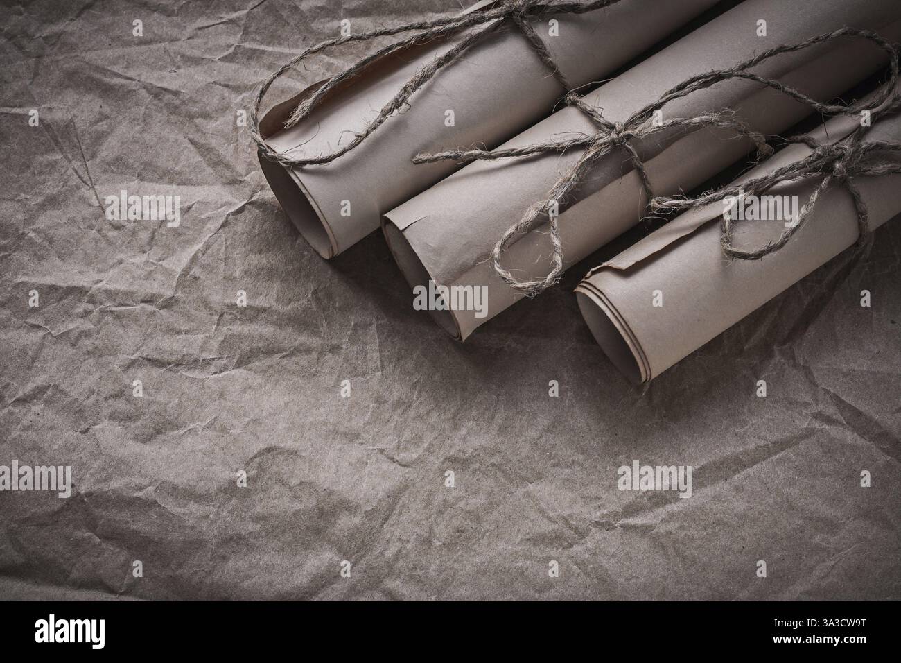 Stack of vintage paper rolls on crumpled wrapping sheet Stock Photo - Alamy