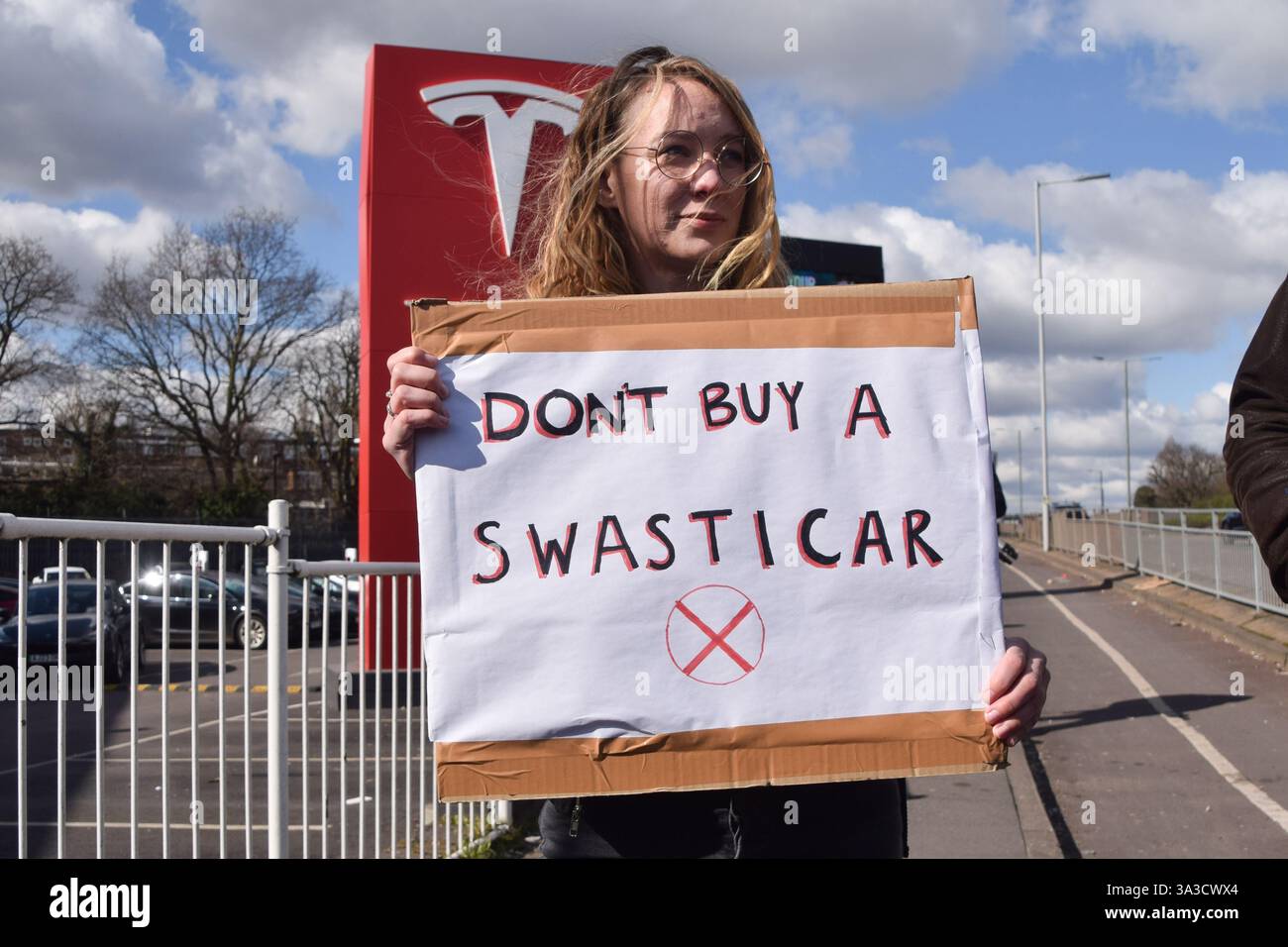 London, UK. 15th March 2025. A protester holds a sign urging people not ...