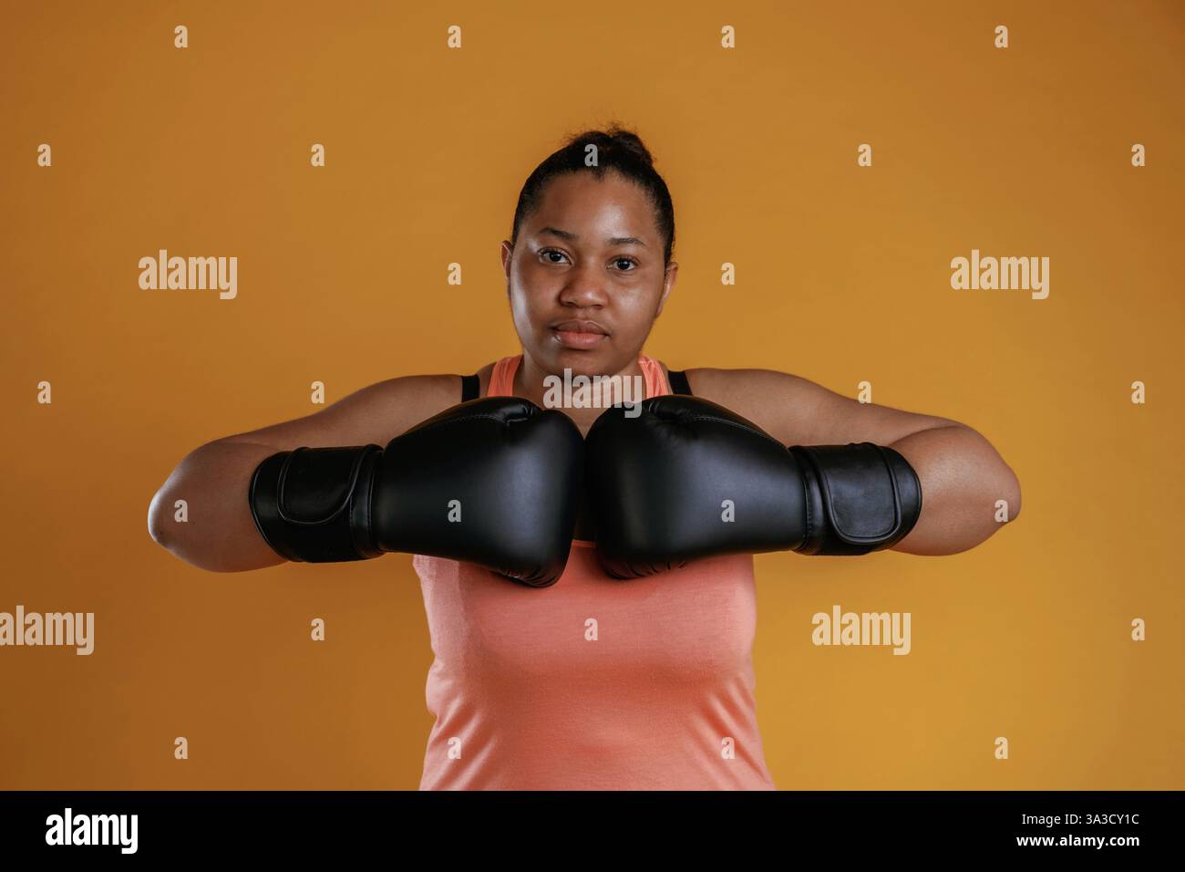 Boxer is ready to fight. African American woman is in the studio ...