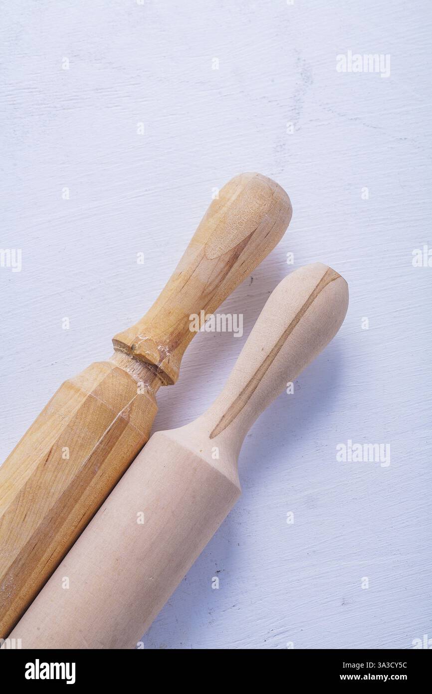 Two rolling pins on white painted wooden board Stock Photo - Alamy