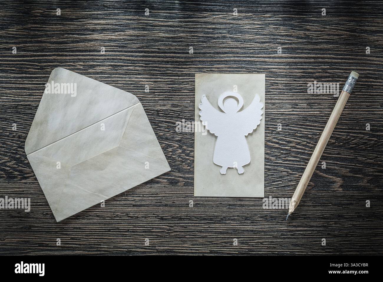 Vintage envelope paper angel pencil on black board Stock Photo - Alamy