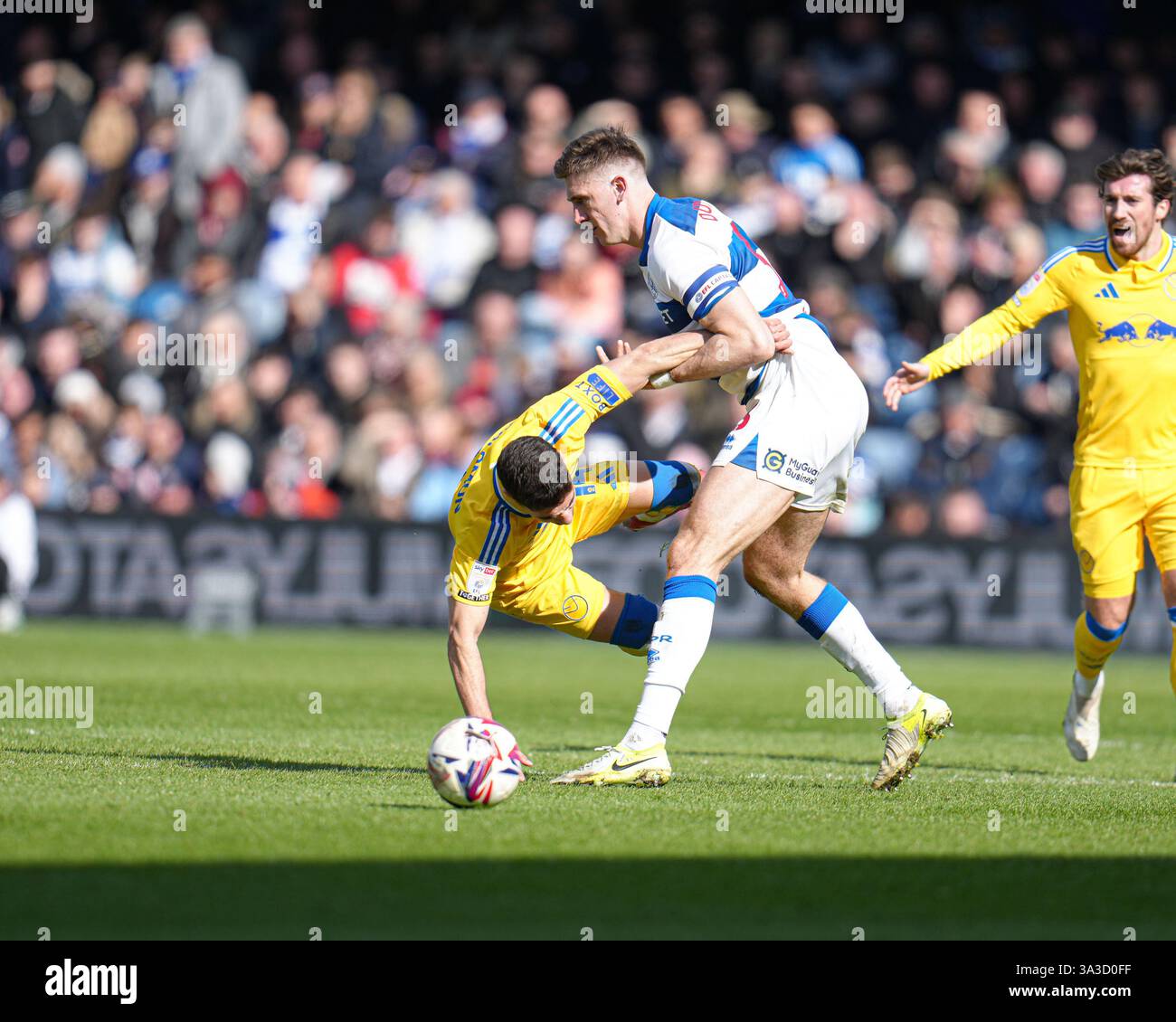 Jimmy Dunne of Queens Park Rangers takes down Manor Solomon of Leeds ...