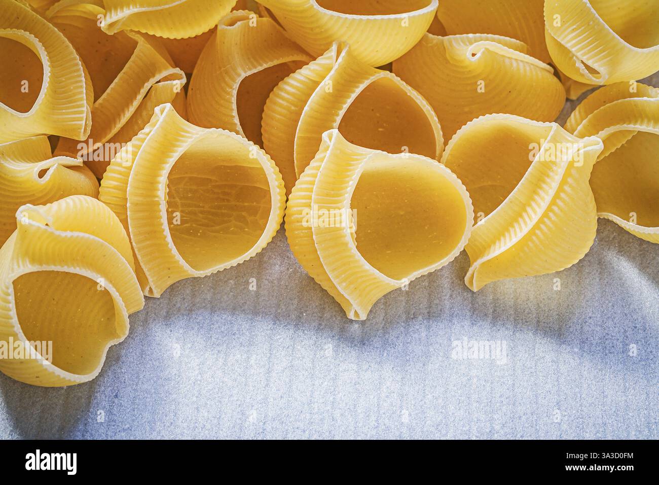 Stack of shell macaroni on blue background food and drink concept Stock ...