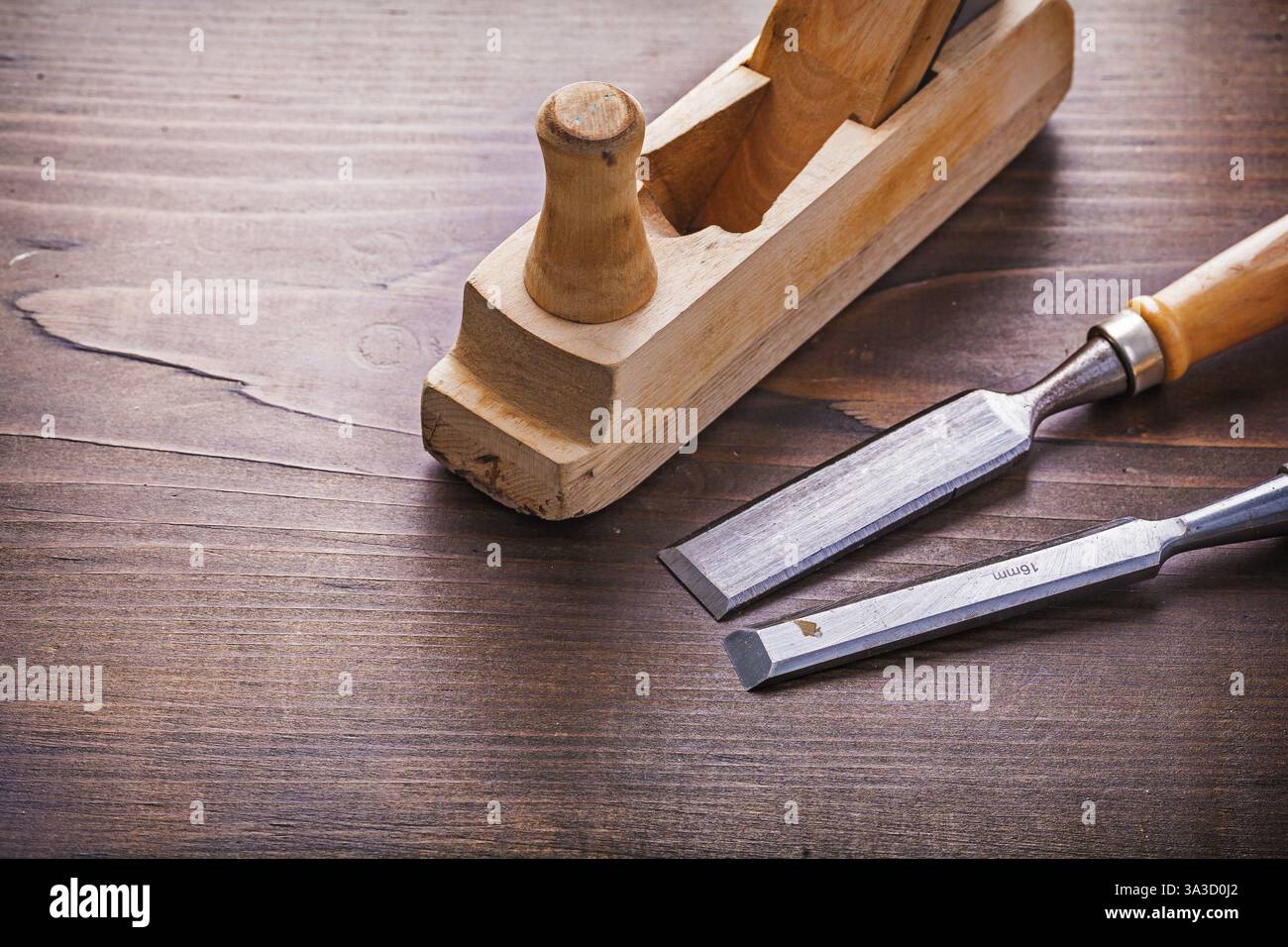 Classic wooden woodworkers plane and carpentry chisel on vintage board ...
