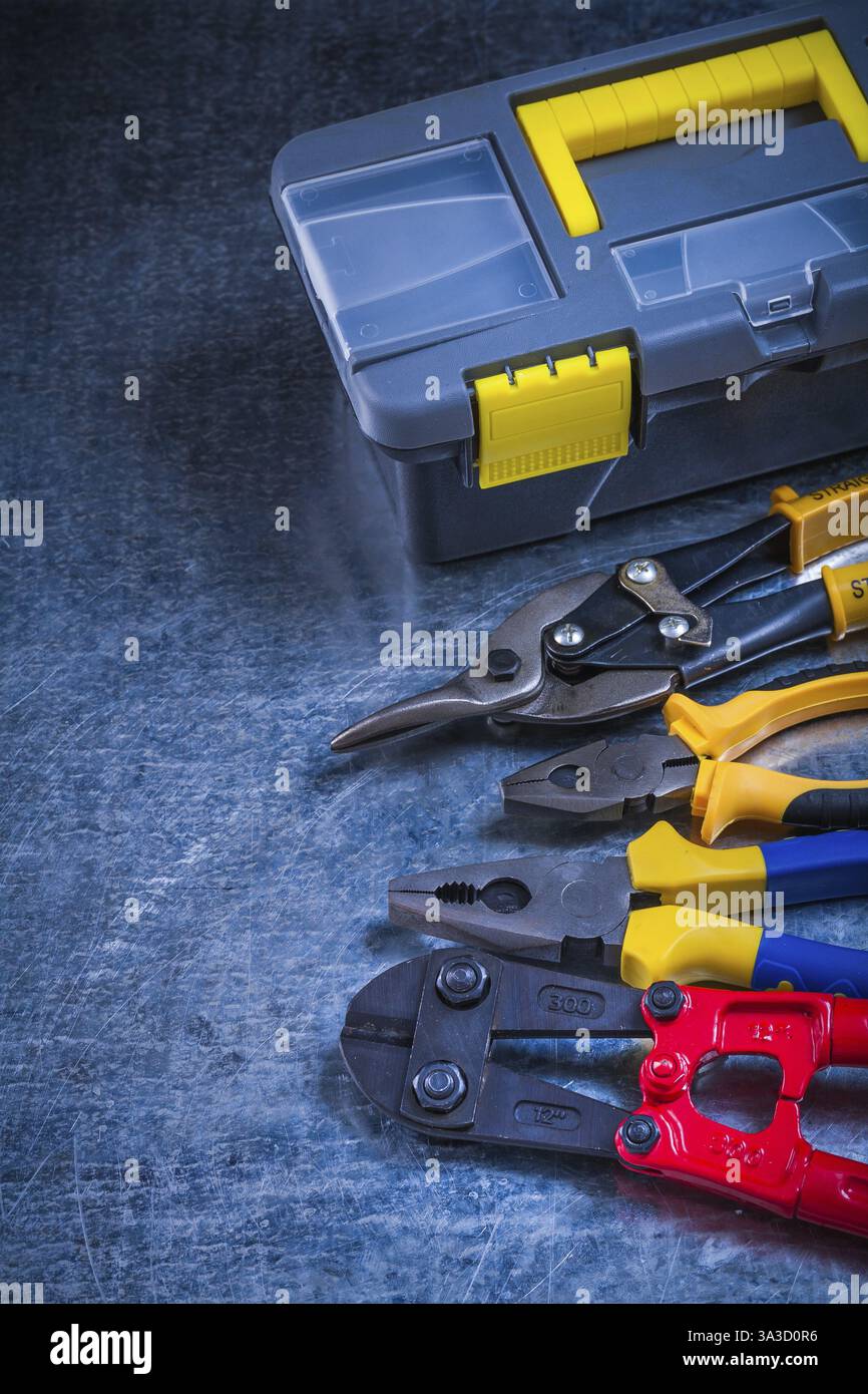 Toolbox bolt cutter pliers and tin snips on scratched metallic ...