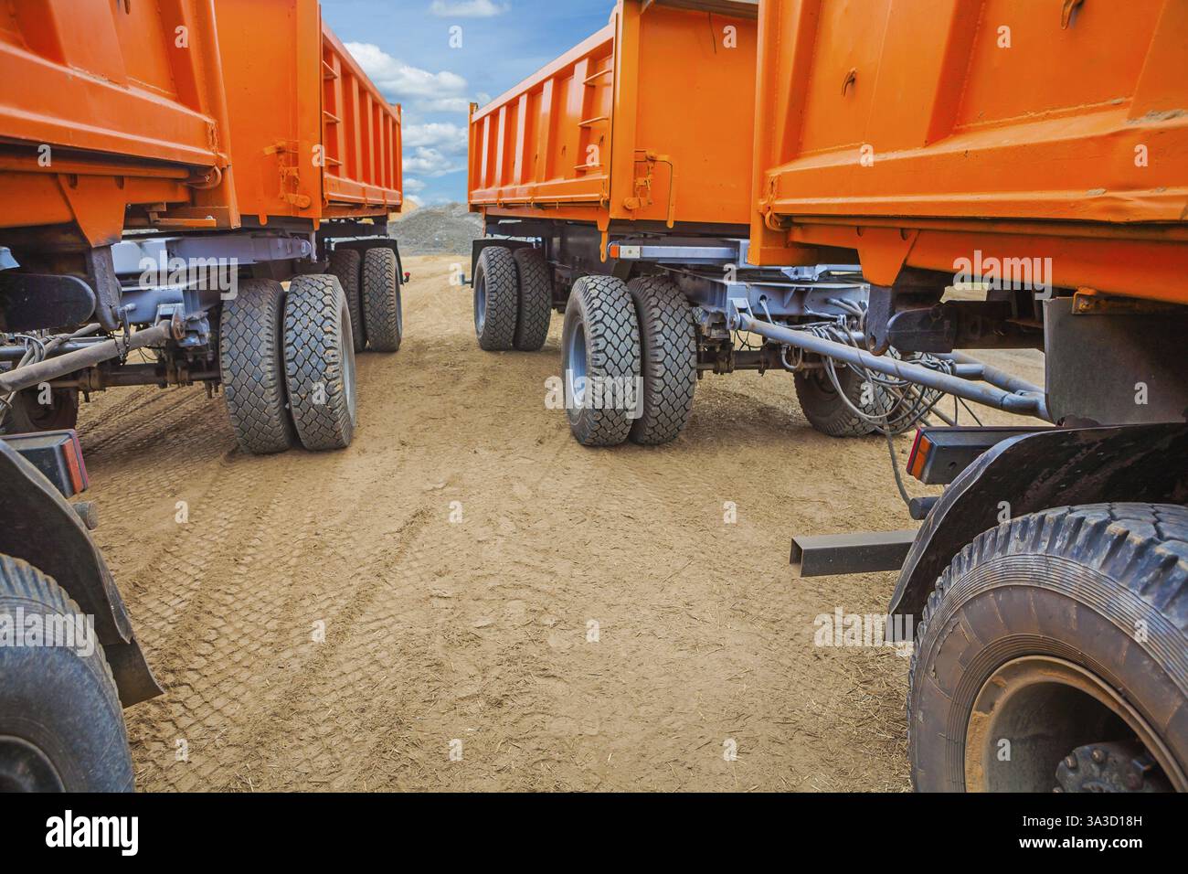View through two rows of tippers Stock Photo - Alamy