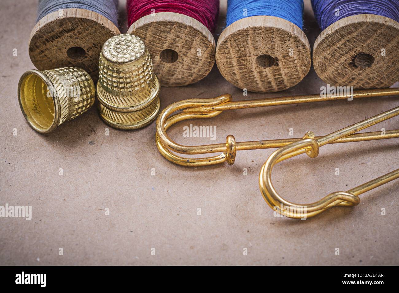 Wooden spools of threads thimbles clasp pins on vintage background Stock Photo - Alamy