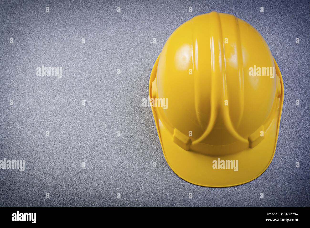 Yellow safety building helmet on grey background construction concept ...