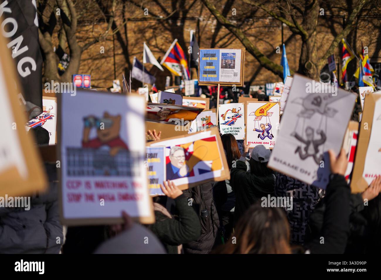 Demonstrators hold placards and banners as they gather outside the ...