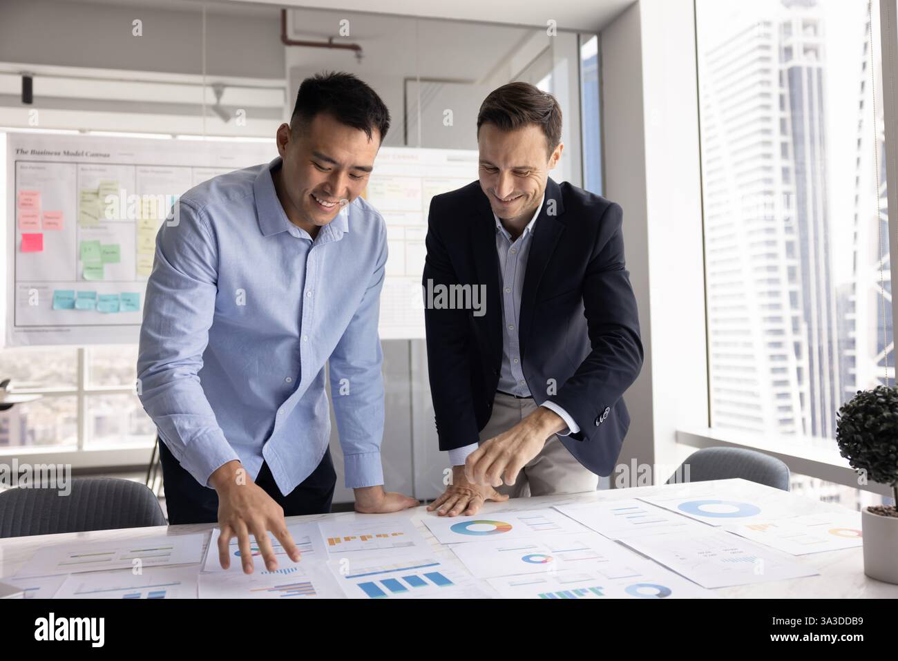 Happy diverse business partner men discussing successful project ...