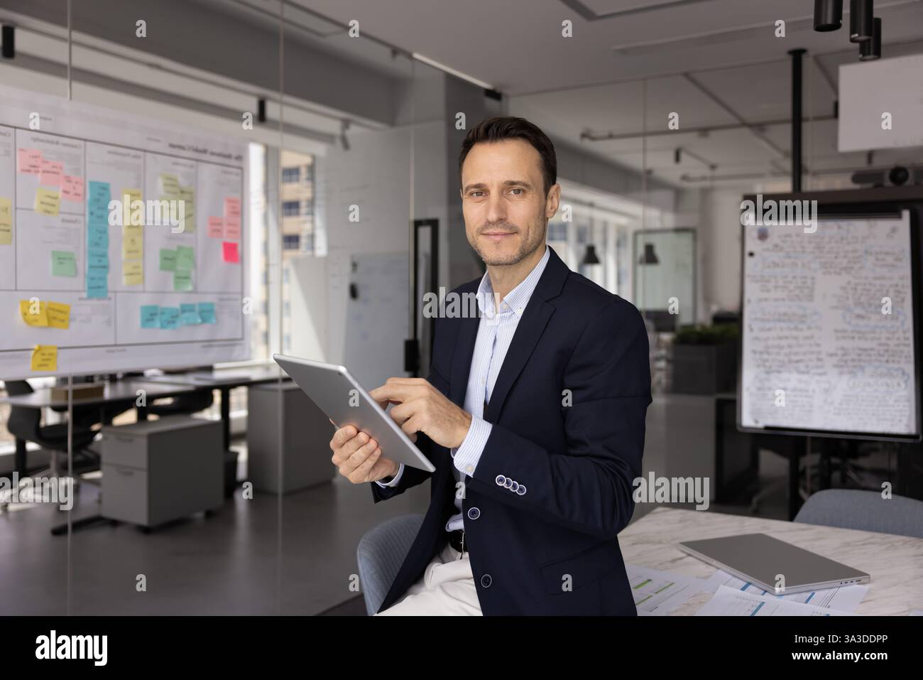 Confident handsome executive man posing in office space alone Stock ...