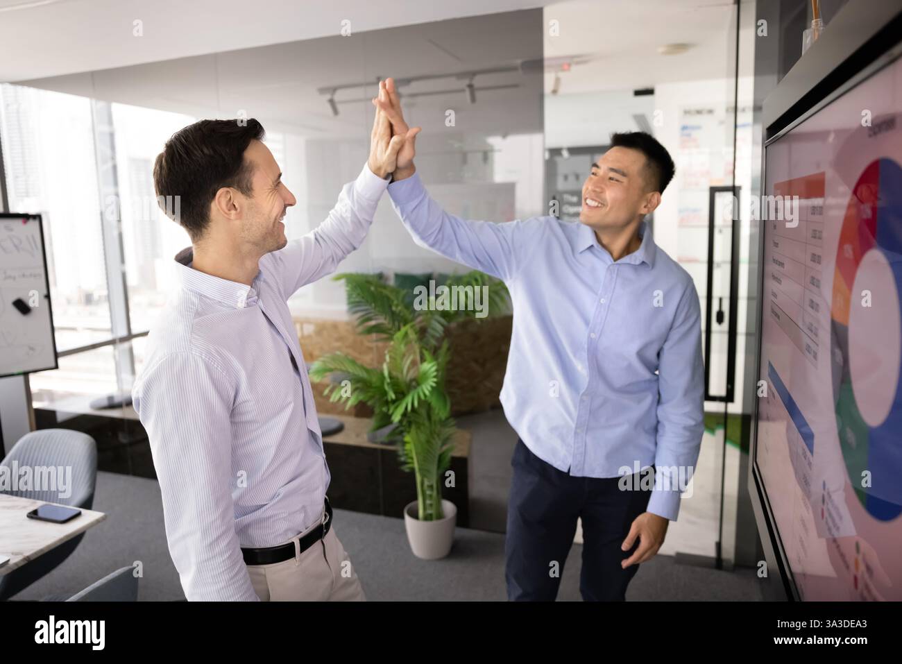 Happy excited diverse business partners giving friendly high five Stock ...
